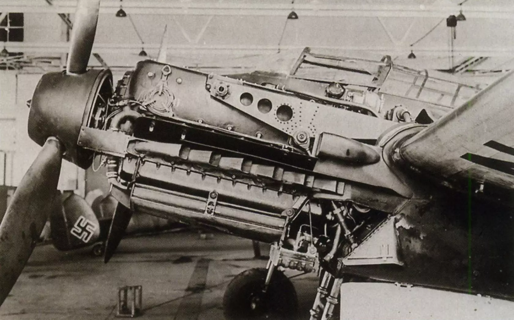 Snapshot Closeup Installation of the DB 601 engine on the prototype FW 187 V-5. Well-distinguished the extended radiator located under the engine. In the background there is a Messerschmitt BF 110 with the Military Number VB + TV. This aircraft served as a test bench for testing DB 601 engines on Focke-Wulf aircraft