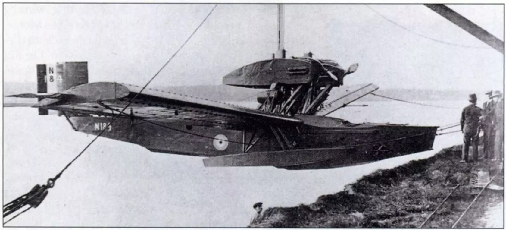 Made of Inverness N184 flying boat with a crane descends to the surface of the Clyde River; Dalmiir