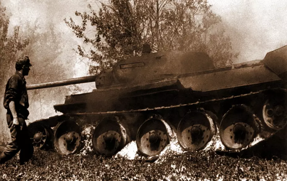 Un soldat allemand passe devant un T-34 mourant, été 1942