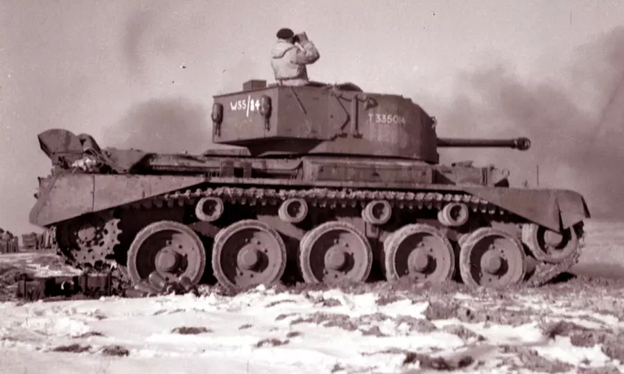 The Comet commander belonging to the 29th Armored Brigade of the 11th Armored Division, observes the results of shooting. France, January 1945 (Imperial War Museum)