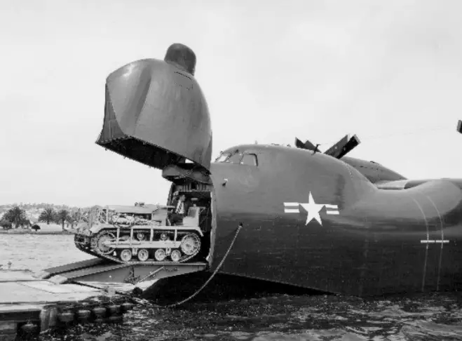In the open cargo compartment of the flying boat R3Y-2 TradeWind tractor loads