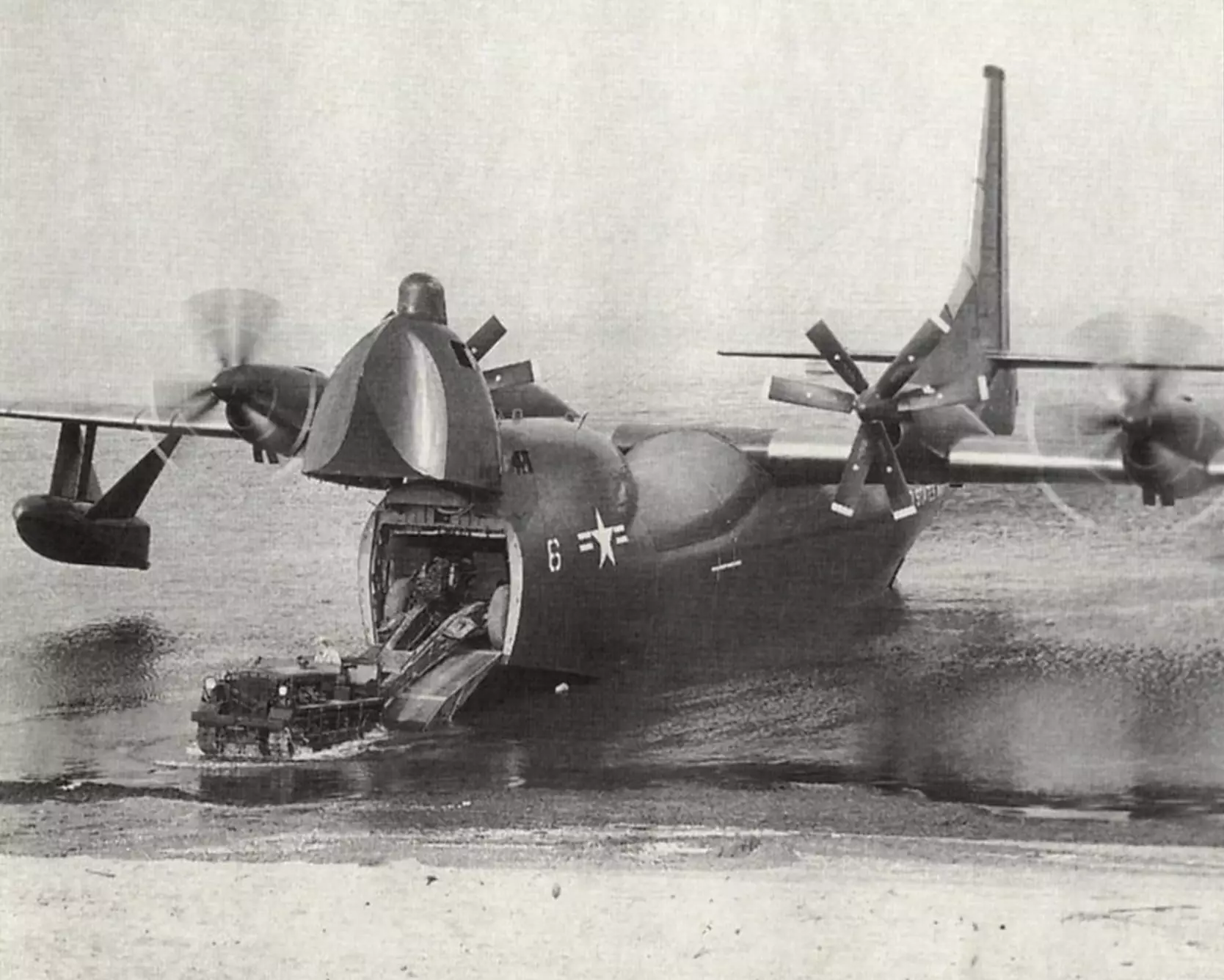 155-mm Maubitis of the Marine Corps is exported by a tractor from an open cargo compartment of a flying boat R3Y-2 TradeWind. As a payload, a 80-ton flying boat could carry guns, trucks and troops to the range of more than 2000 miles (3220 km)